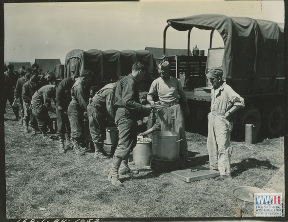 Field mess served near field kitchen truck during training maneuvers at Camp Cooke, California ...